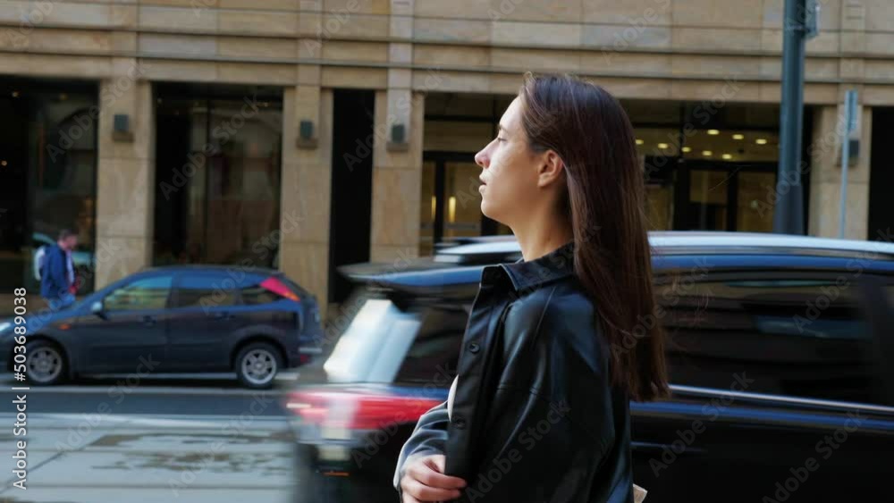 Confident woman walking down street. Side view. Beautiful career girl ...