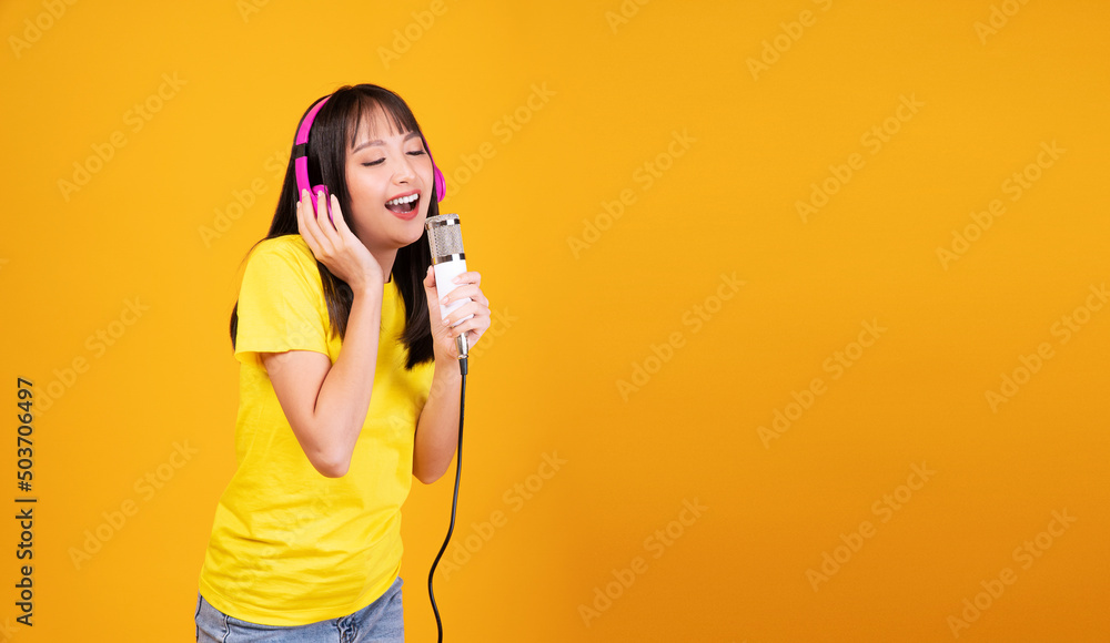 Enjoy singer Asian young woman wear casual with pink headphones listen ...