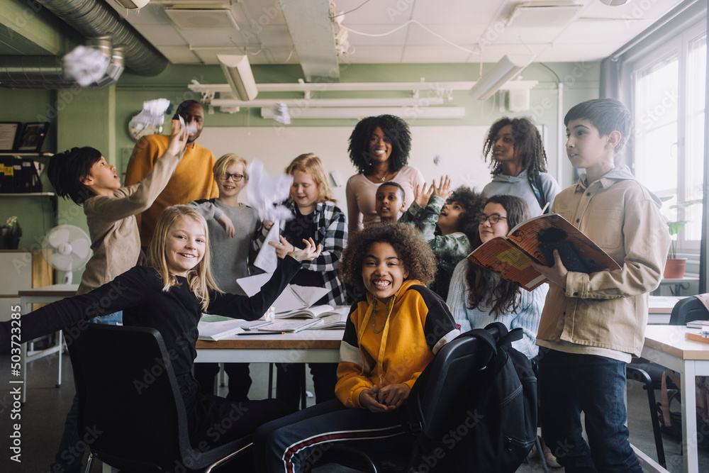 Cheerful group of students with teachers in classroom at school Stock ...