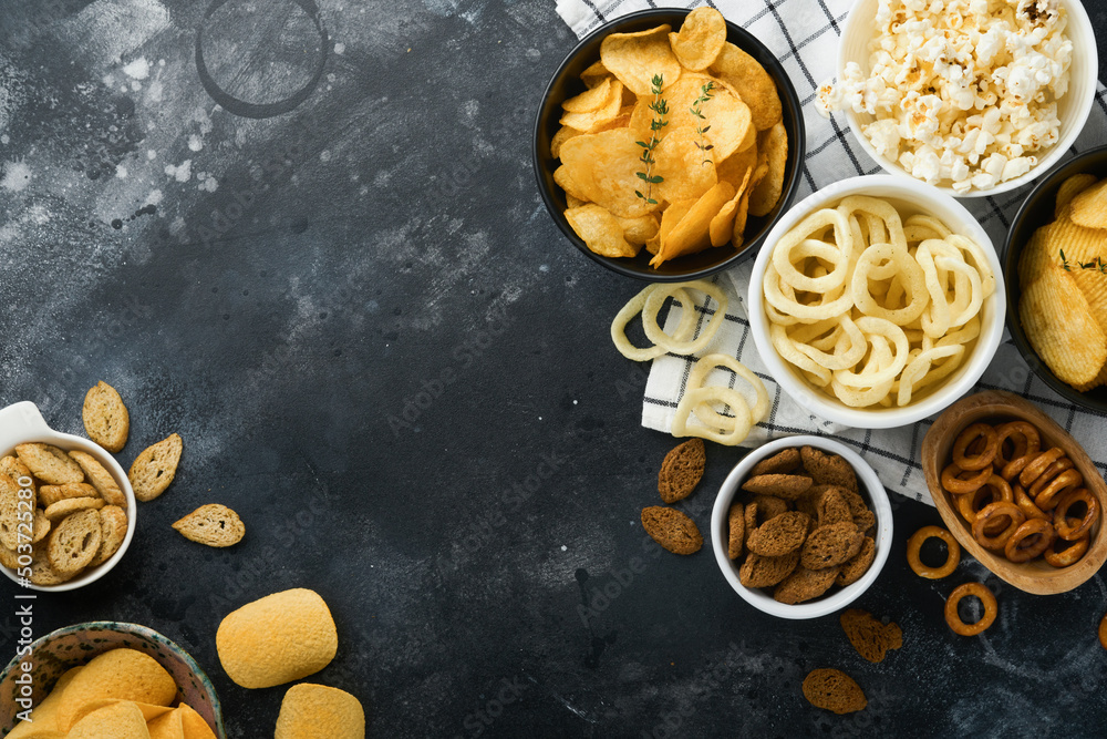 Unhealthy food. Snacks. All classic potato snacks with peanuts, popcorn ...