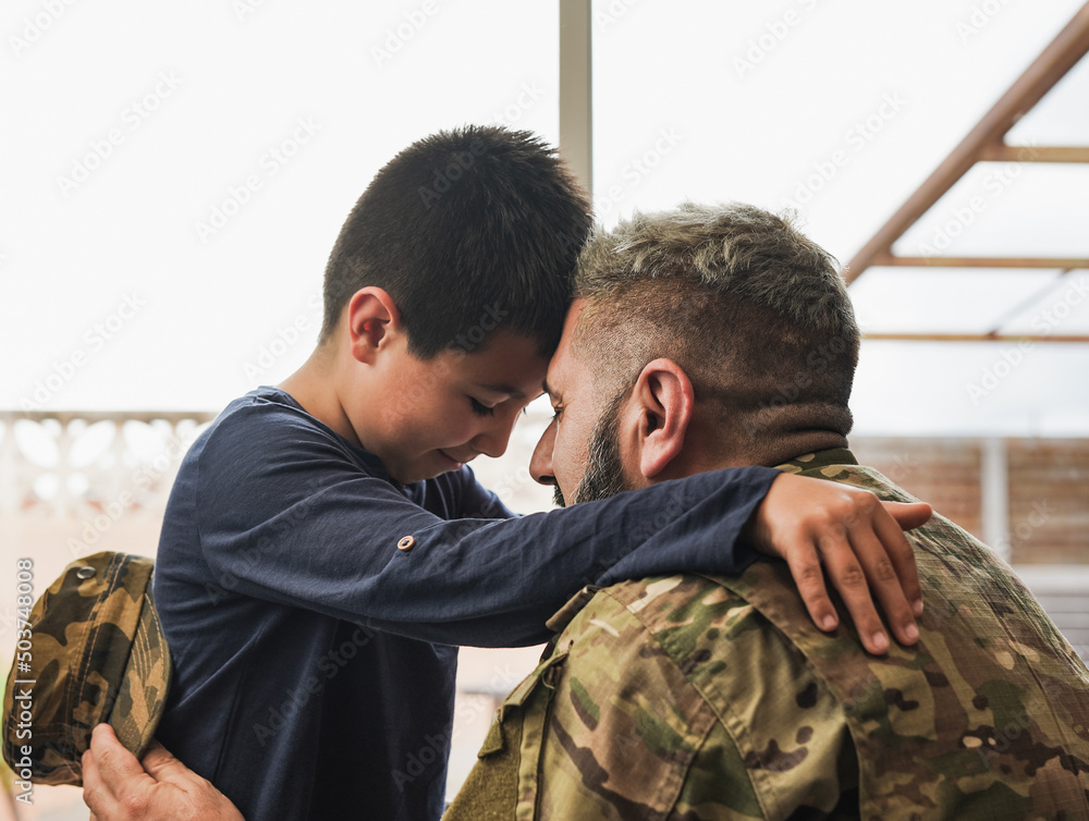 Military soldier man hugging his son at home - Father and child love ...