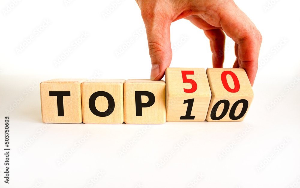 From Top 100 to 50 symbol. Businessman turns wooden cubes and changes ...