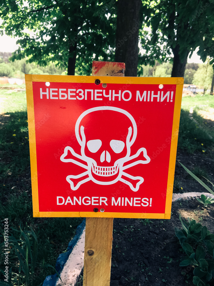 Sign with the inscription in English and Ukrainian "Danger Mines ...