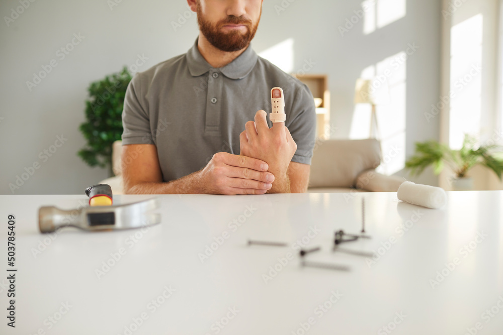 Close up of injured man hit finger with hammer have bandage for fast ...