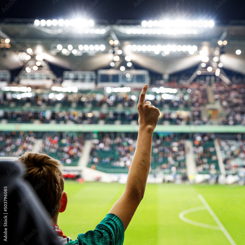 Football fan with raised hands at the stadium during his favorite team ...