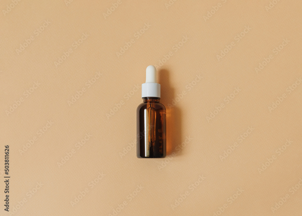Serum. Top view photo in minimal style. Liquid cosmetic in brown glass ...