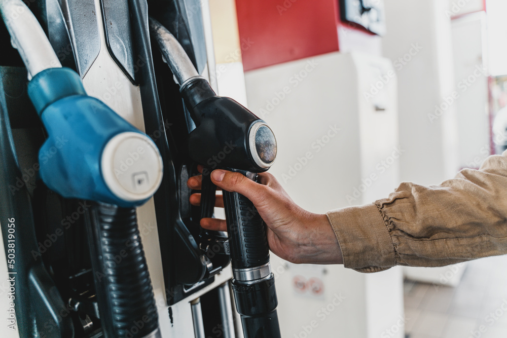 Fuel pump fill a tank of a car in a station Stock Photo | Adobe Stock
