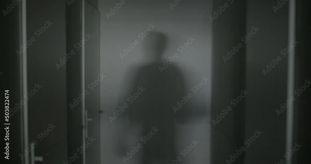 Camera movement, silhouette of a man, shadow on the wall, scratching ...