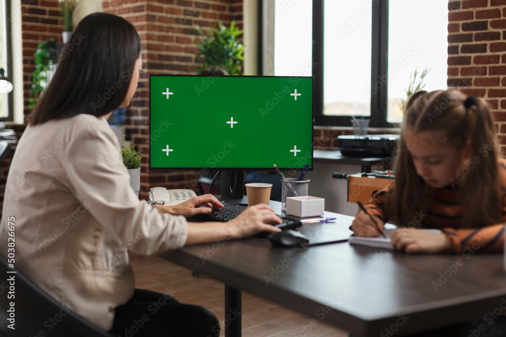 Young businesswoman using work computer with blank mock up template ...