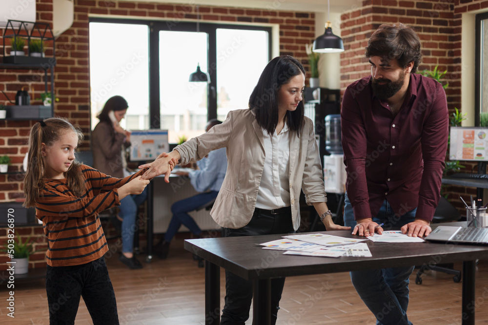 Annoying little girl disturbing busy working young mother while she ...