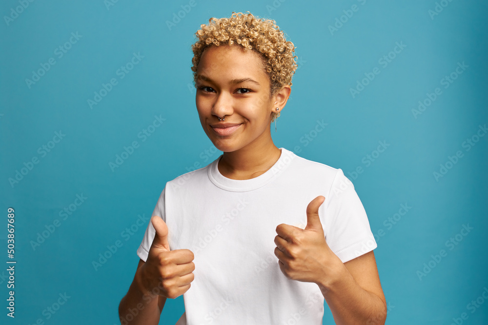 Cool African teenage girl in casual mockup t-shirt showing thumbs up ...