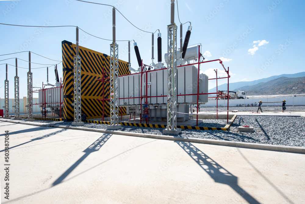 High voltage transformer under the sunny blue sky to generate power. Electric current ...