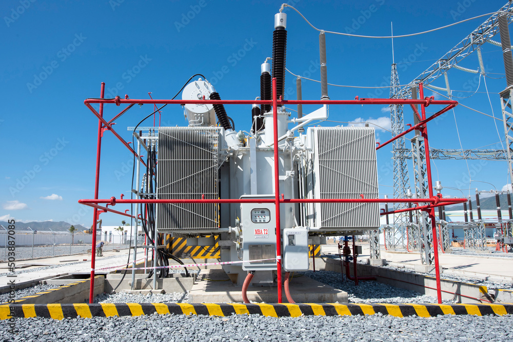 High voltage transformer under the sunny blue sky to generate power ...