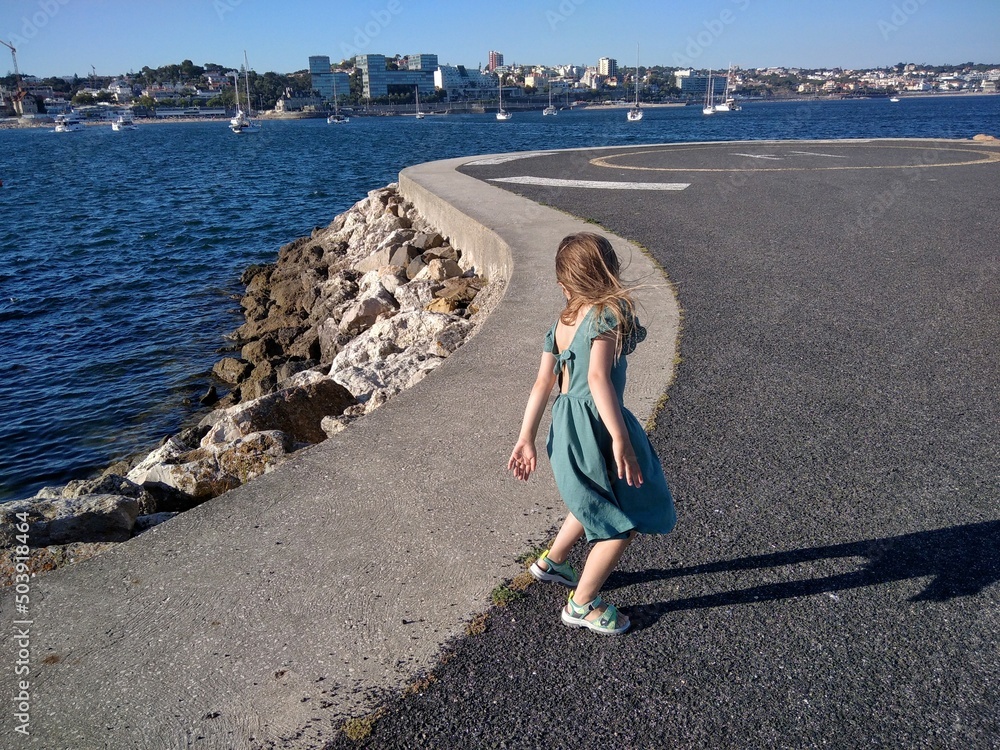 Little girl at the bay of the Atlantic Ocean. Stock Photo | Adobe Stock