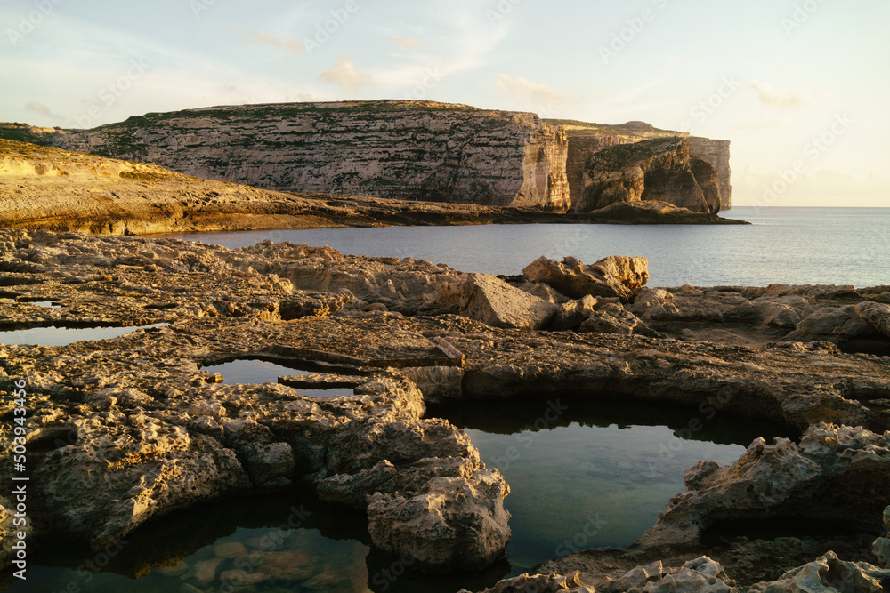 Fungus Rock and rock pools at Dwejra Bay on the western coast of the ...