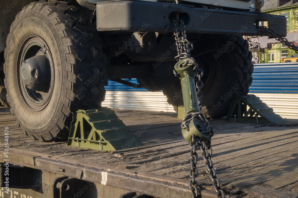 Off-road truck fixed with chains and pads on the freight railway ...