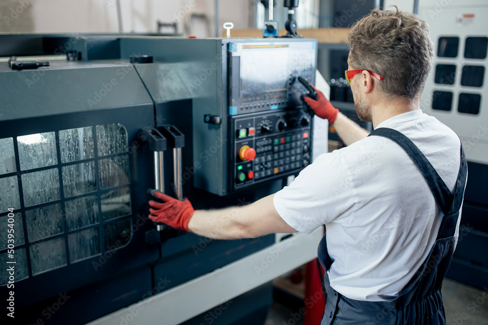 Engineer man work on CNC machine at automatic factory floor. Concept ...