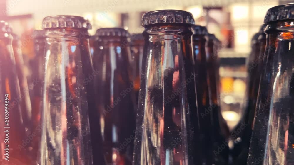 Bottles of dark beer stand on a shelf in a liquor store, ABC store ...