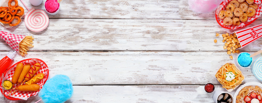 Carnival theme food double border over a white wood background ...