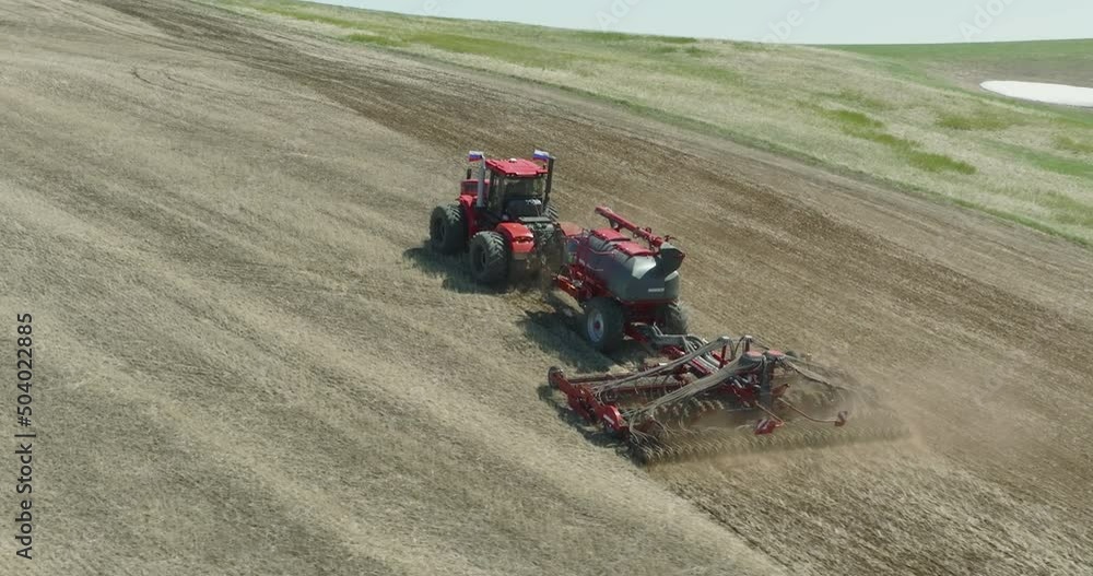 Tractor sowing seeds with seeder driller in field. Process of sowing ...