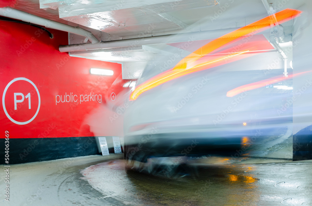 Commercial Parking Lot Level 1 Sign on Red Wall with White Car Driving ...