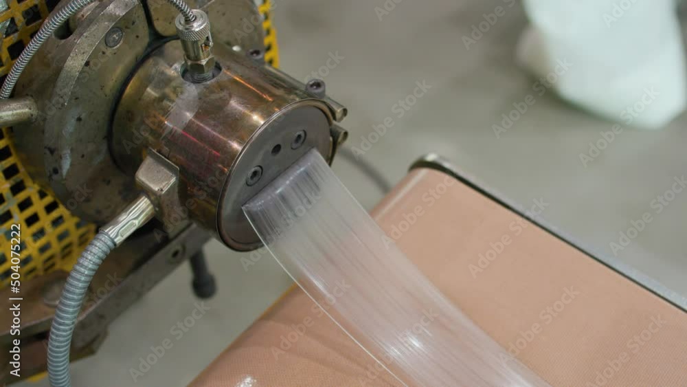 Plastic compound sheet coming out of extrusion machine on to the belt ...