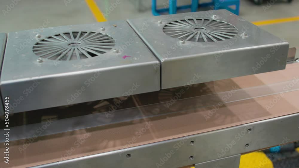 Fans cooling plastic sheet out of single screw extruder machine ...