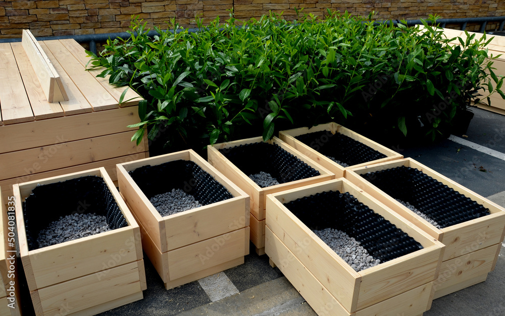 preparation for planting flower pots. wooden flower pots are filled at ...
