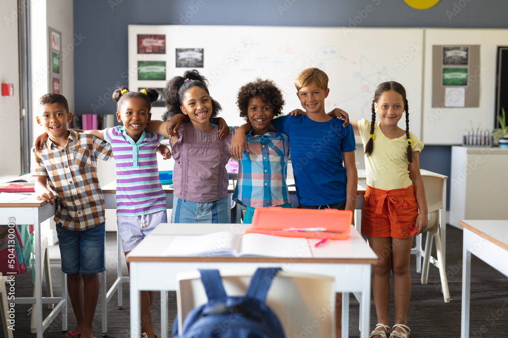 Portrait of smiling multiracial elementary school students standing ...