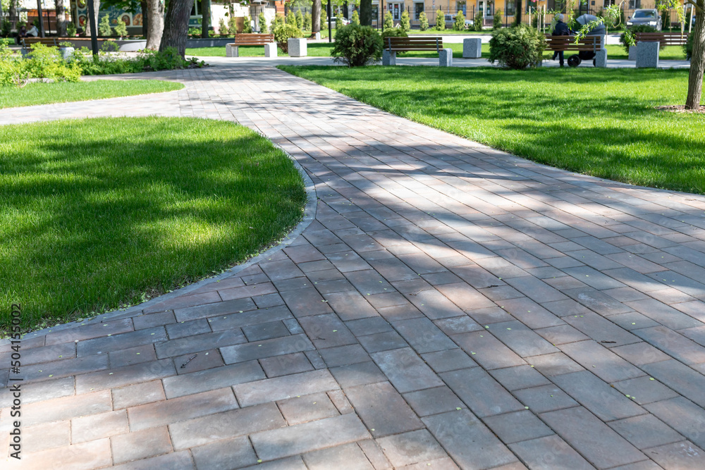 Paving with paving slabs. Landscape architecture of a park. Decorative ...