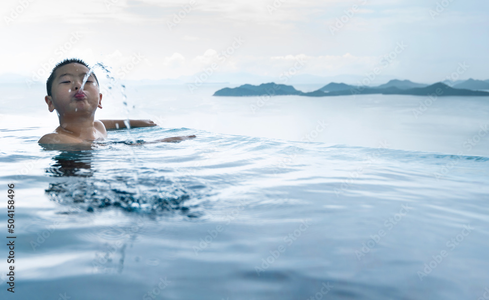 Boy swimming and spitting water from mouth Stock Photo | Adobe Stock