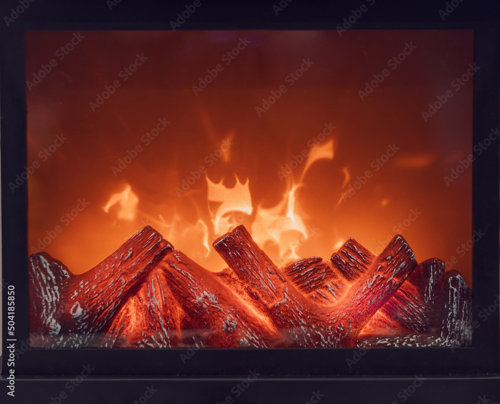 Fireplace with bright flames. Artificial decorative fireplace with ...