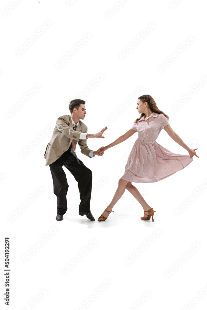 Young man and woman in vintage retro style outfits dancing social dance ...