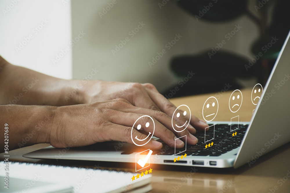 Businessman pressing pressing face emoticon on the laptop on desk and ...