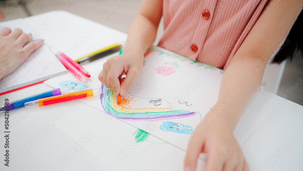 Girls sitting in the kindergarten school classroom with teacher during ...