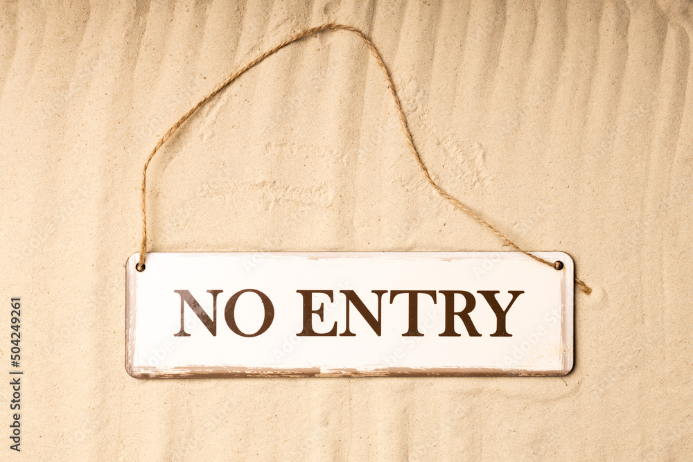 entry is prohibited is written on the sign which is located on the sand ...