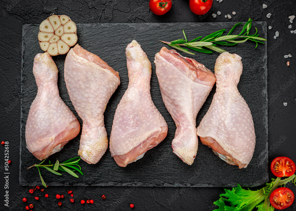 Raw chicken drumsticks with spices and vegetables. Stock Photo | Adobe ...