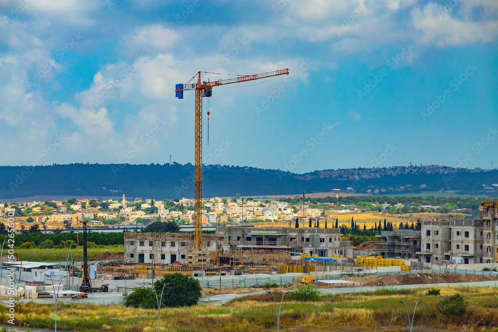 Migdal HaEmek, Israel - May 2022: Yellow construction building cranes ...