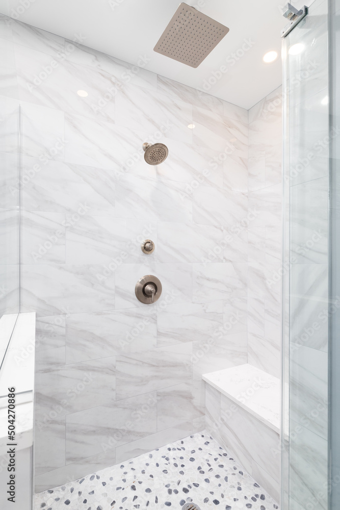 Stockfoto A luxury walk-in shower with marble tiles on the walls and ...