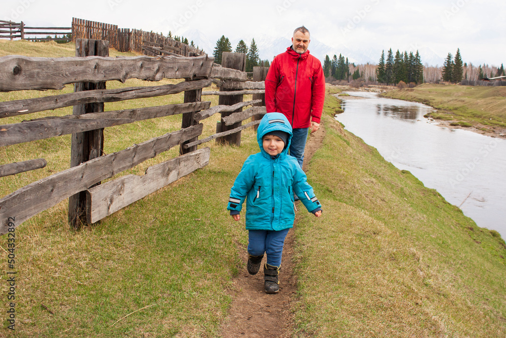 Father and son standing on forest road spending happy time together on ...