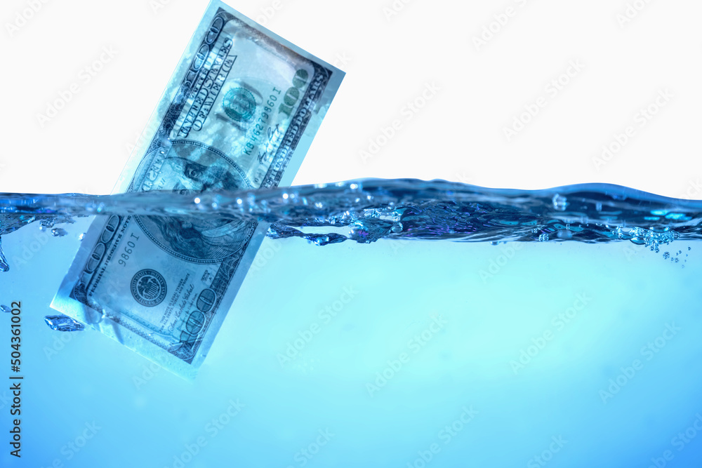 US Dollar bill sinking in water as a symbol of global economic crisis ...