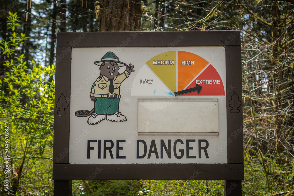 Sign depicting fire danger index in forest with warning set at extreme ...