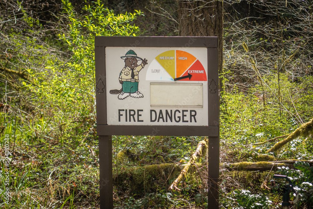 Sign depicting fire danger index in forest with warning set at extreme ...