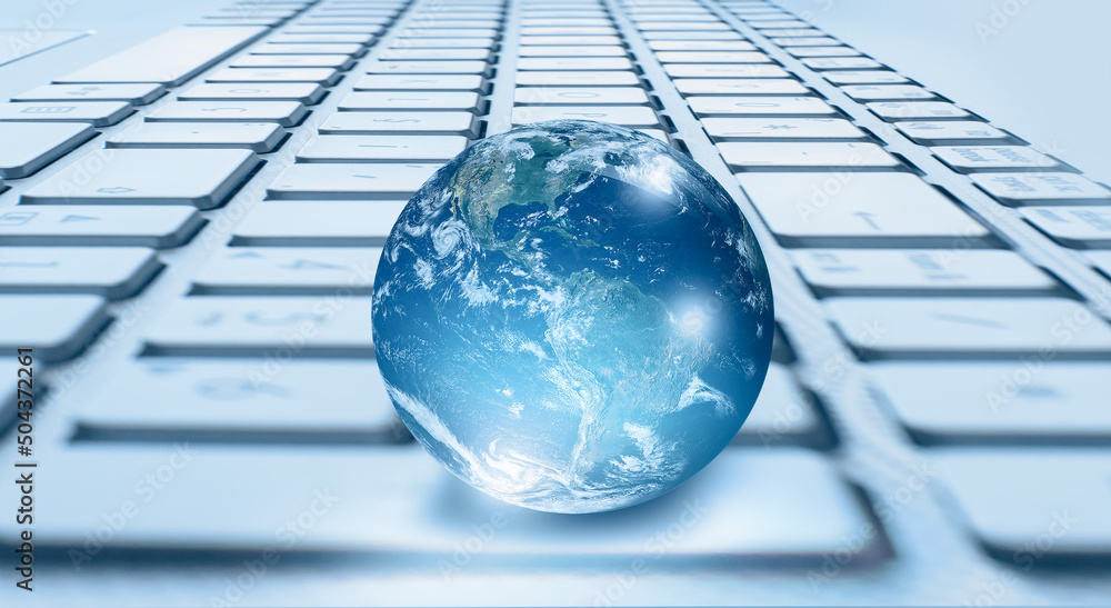 Glass globe on blured laptop keyboard "Elements of this image furnished ...