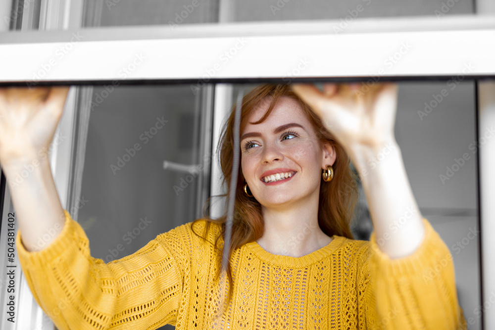 Woman hand hold retractable pleated insect screen holder to open or ...