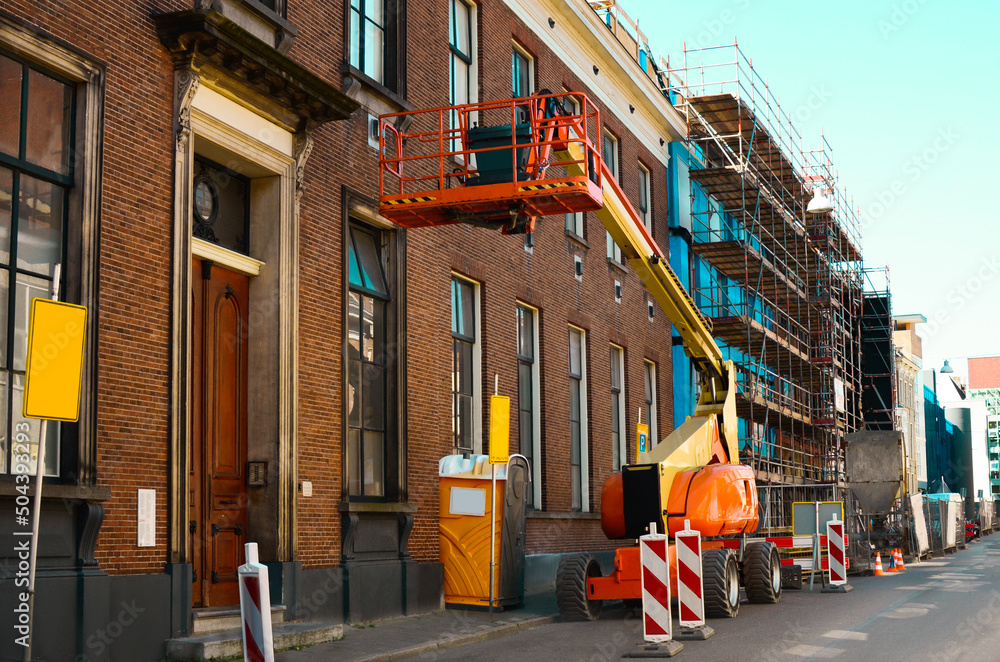 Telescopic boom lift near modern building on city street Stock Photo ...