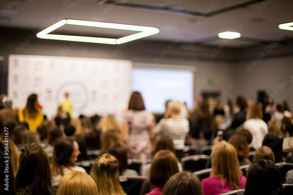 Abstract blurred photo of conference hall or seminar room with speakers ...