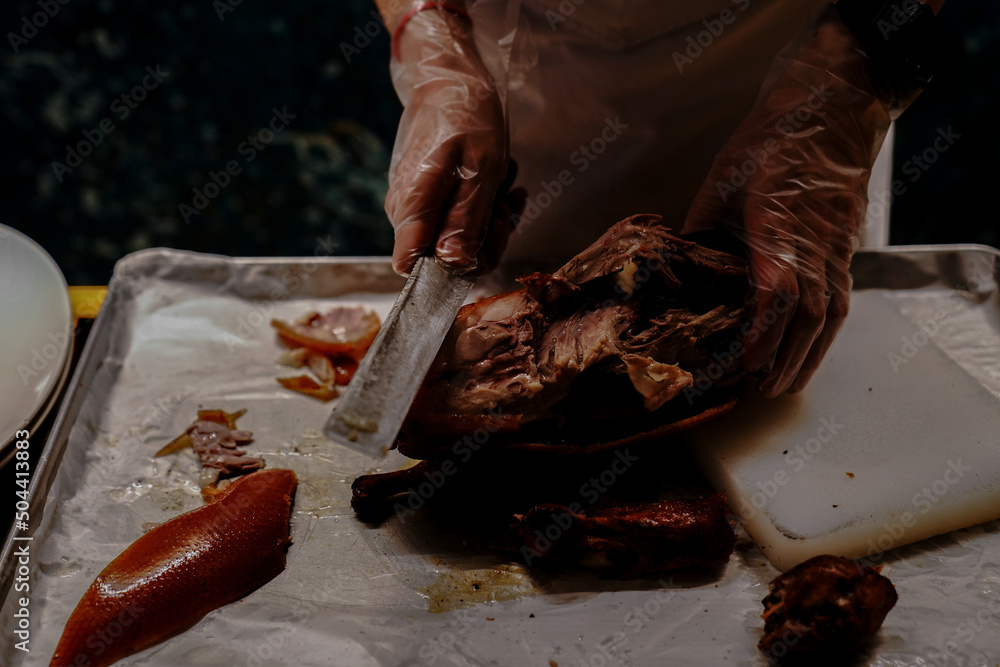 Chinese cook prepares Peking Roast Duck. Peking Duck is a famous duck ...