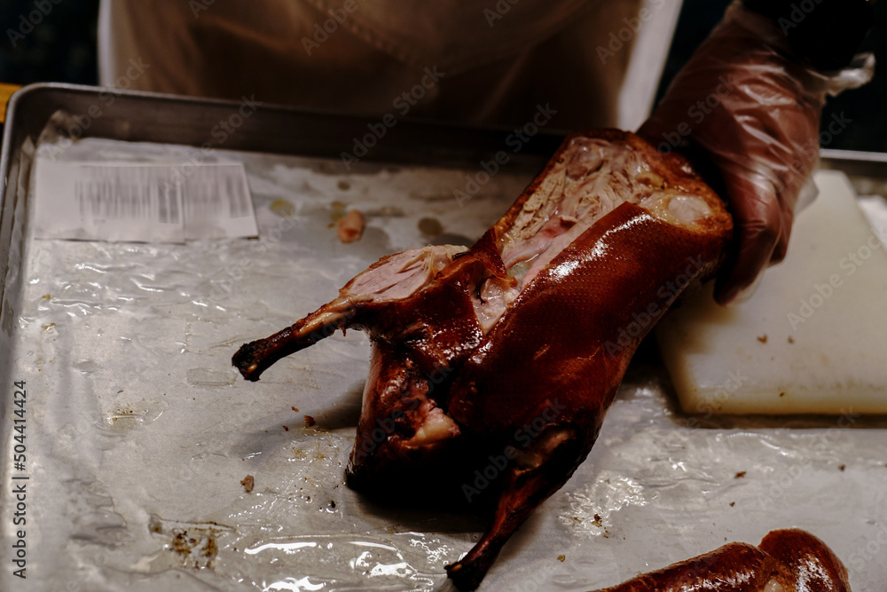 Chinese cook prepares Peking Roast Duck. Peking Duck is a famous duck ...
