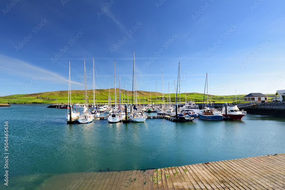 Colorful fishing boats and yachts at the harbor of Dingle town on the ...